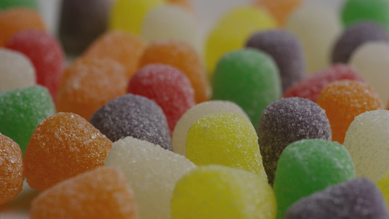 Texture of colored gummies spinning slow - Free Stock Video
