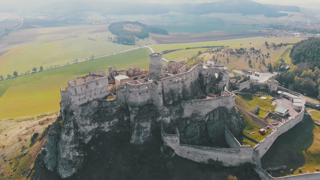 Aerial view of an old castle on top of a hill - Free Stock Video