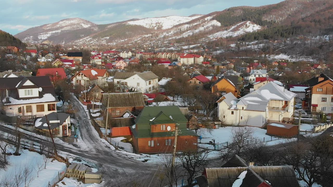 Flying over a small town during the winter - Free Stock Video