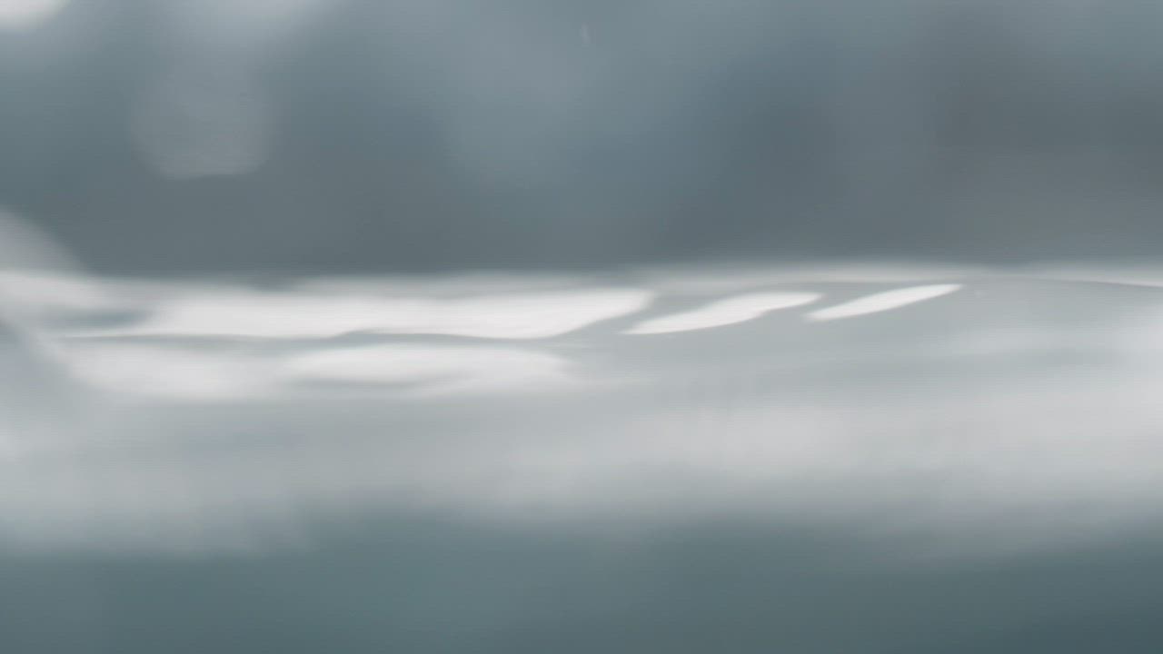 Shallow view of water as drops fall - Free Stock Video