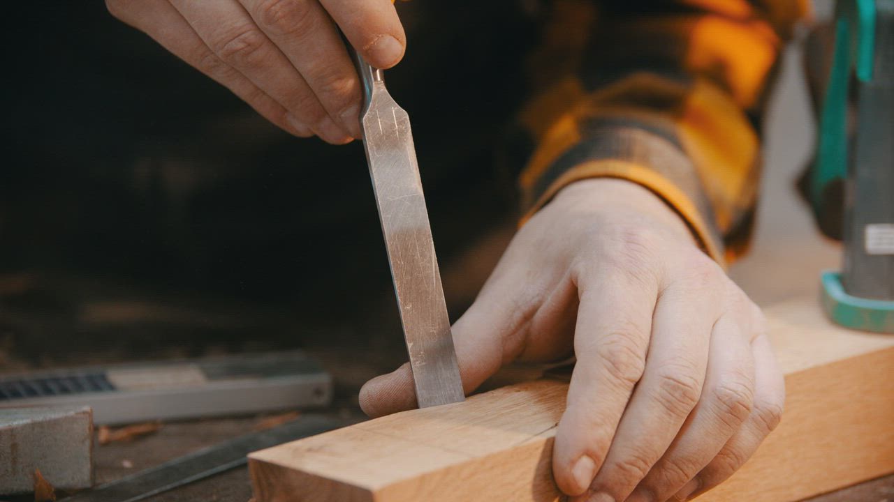 Carpenter shaping board with chisel and mallet - Free Stock Video