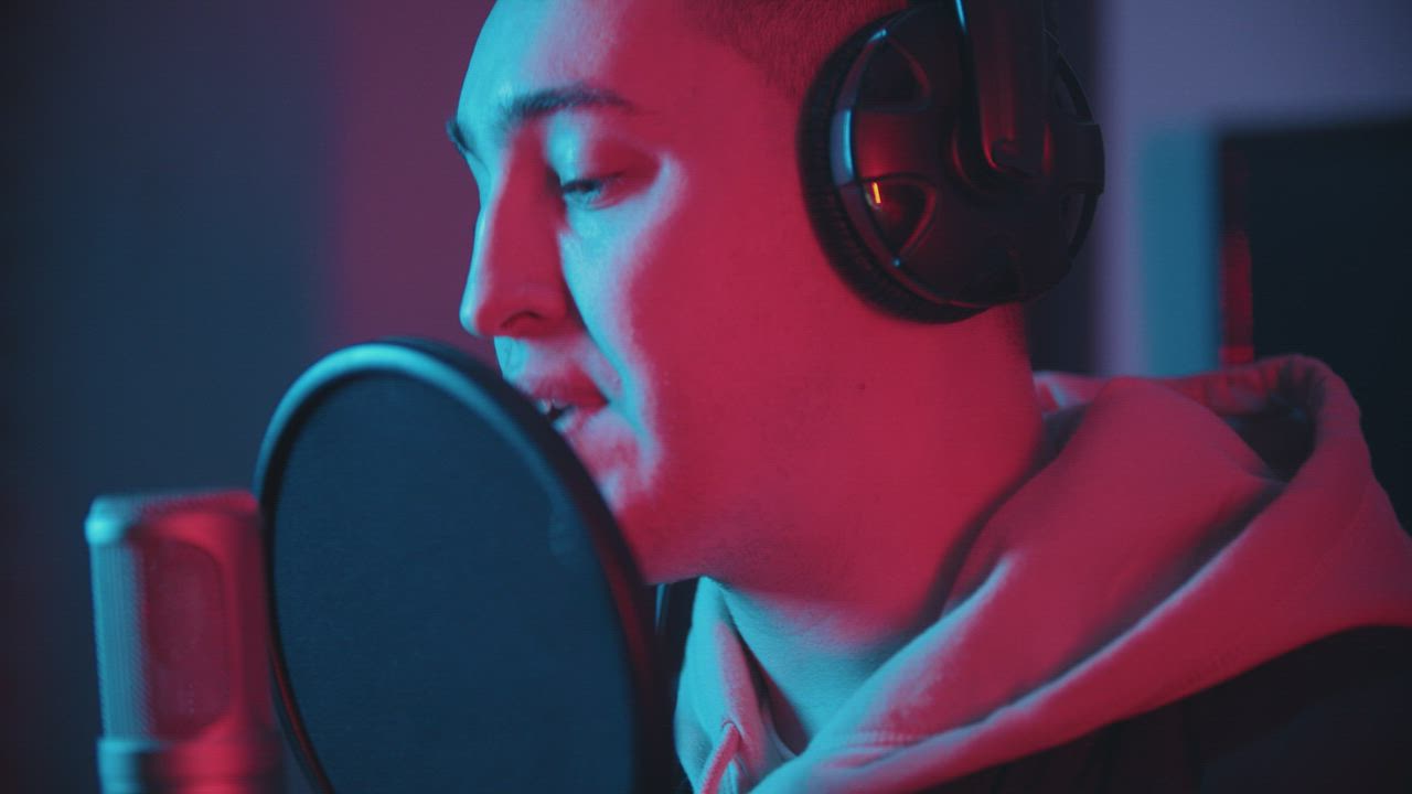 Rapper recording with a microphone in a recording studio - Free Stock Video