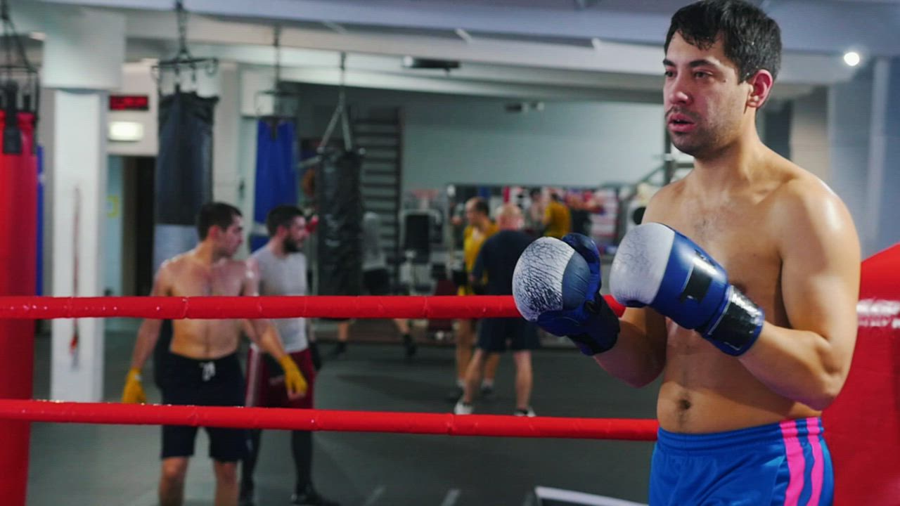 Two men practicing boxing on a ring - Free Stock Video