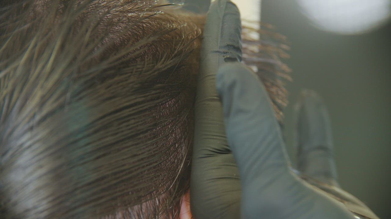 Cutting a man's hair in a close up shot - Free Stock Video