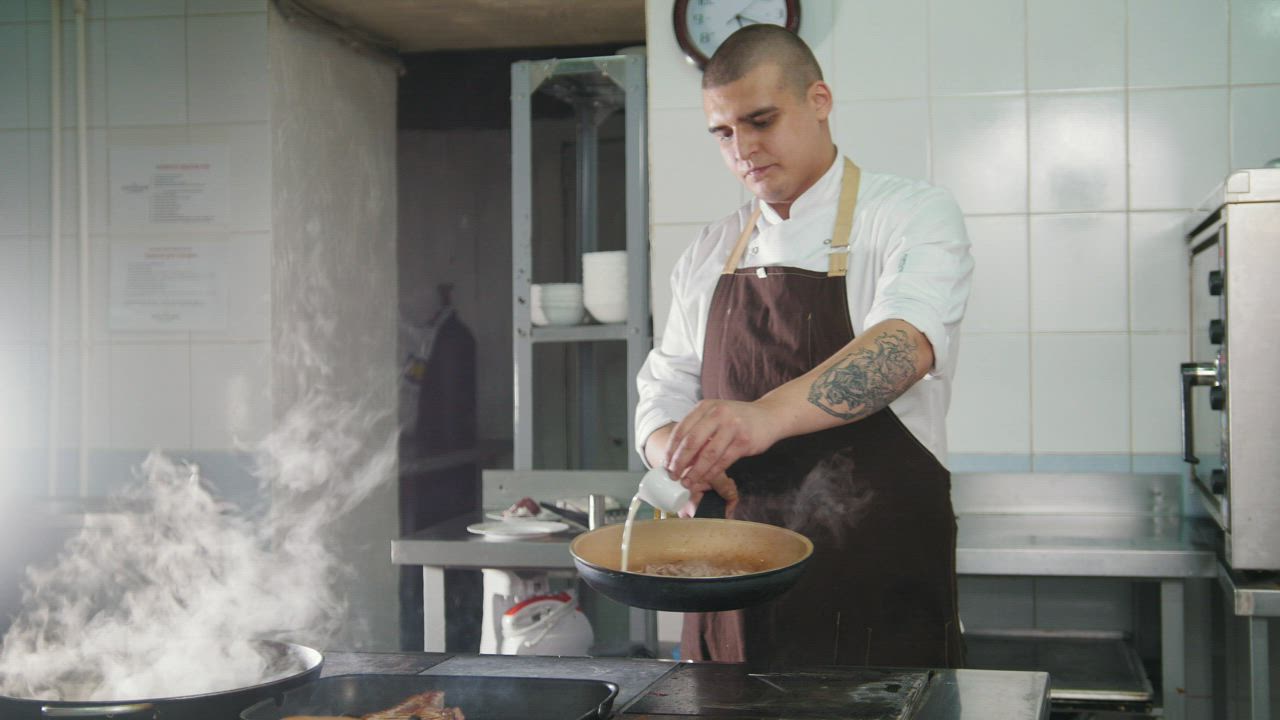 Professional chef cooking in a restaurant kitchen - Free Stock Video