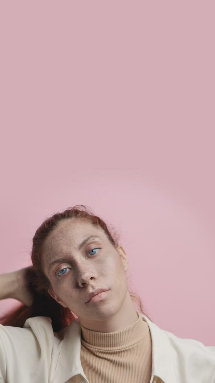 Girl modeling captivatingly on a pink background - Free Stock Video