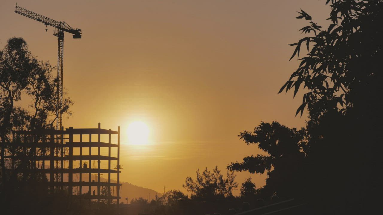 Sunset behind a building under construction - Free Stock Video