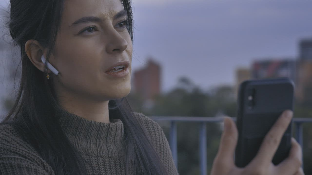 Face of a woman having a video call outdoors - Free Stock Video