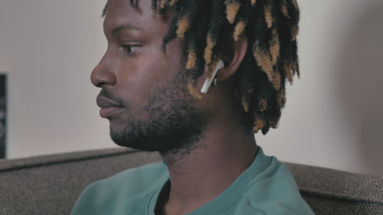 Face of a man listening to music while reading a book - Free Stock Video