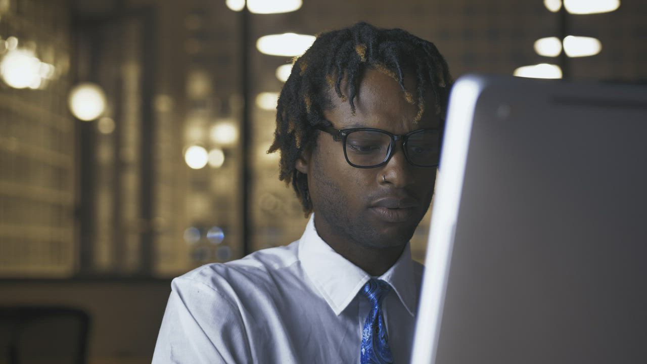 Portrait of a man working overtime in the office - Free Stock Video