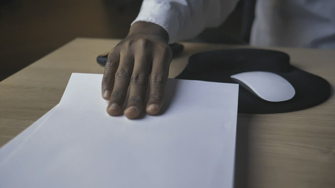 Hand of a person taking a blank sheet of paper - Free Stock Video