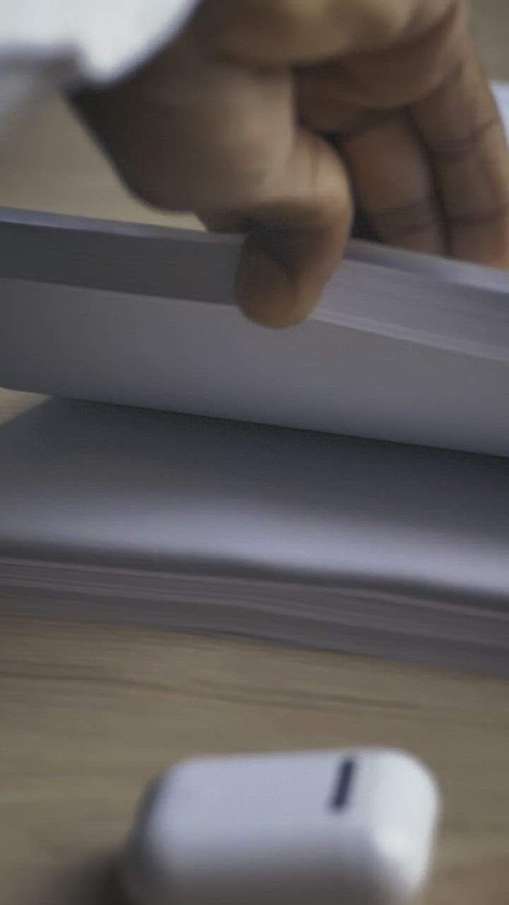 Hand of a man in an office taking a sheet of paper - Free Stock Video