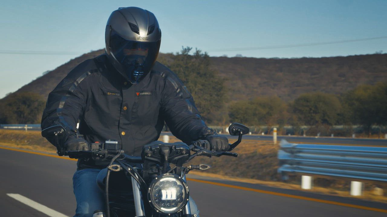 Riding a motorcycle speeding down a road at sunset - Free Stock Video