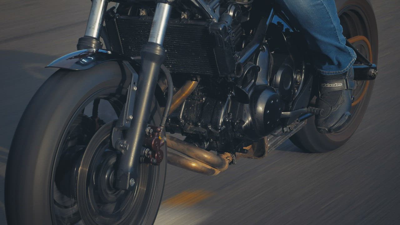 Wheels of a motorcycle traveling fast down a road - Free Stock Video