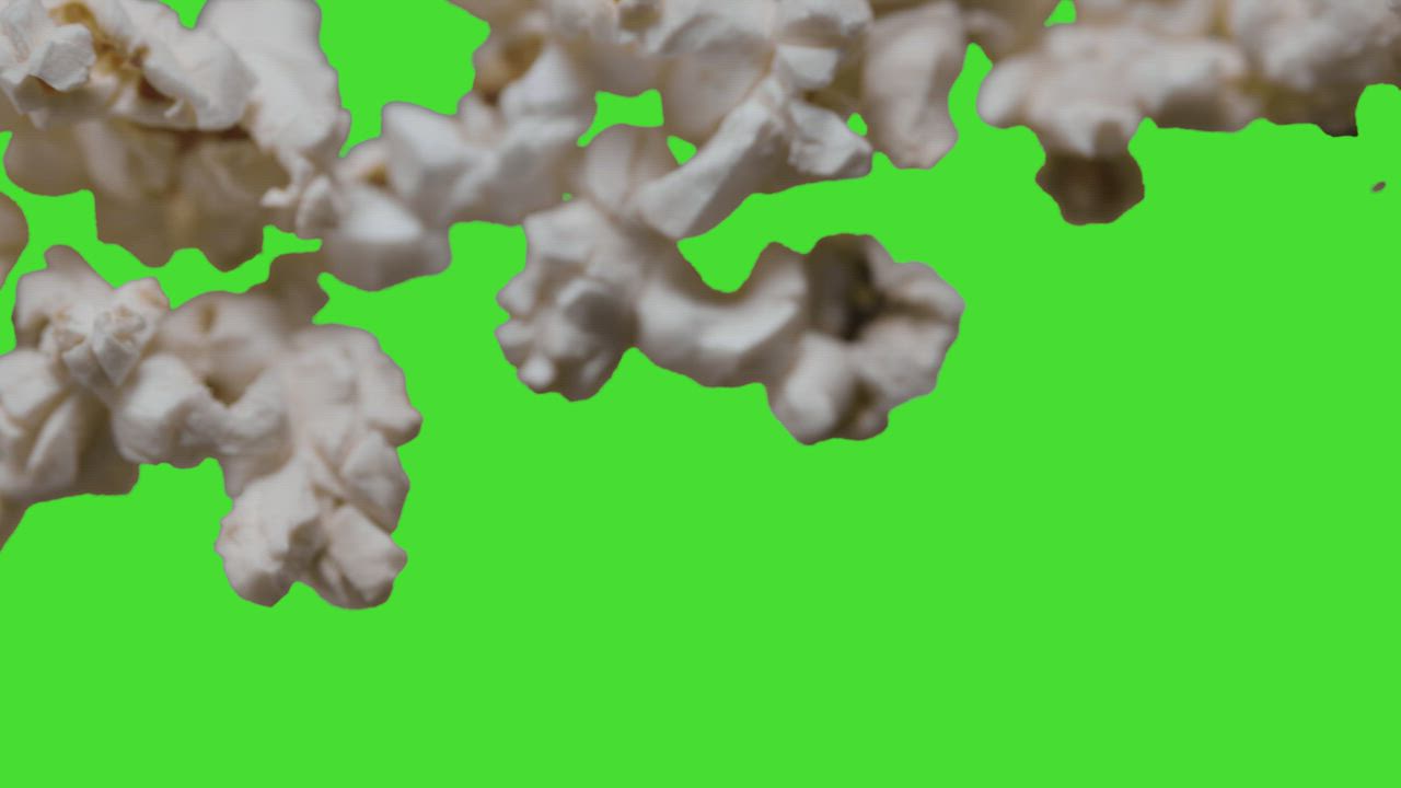 Popcorn on a green background, stop motion - Free Stock Video
