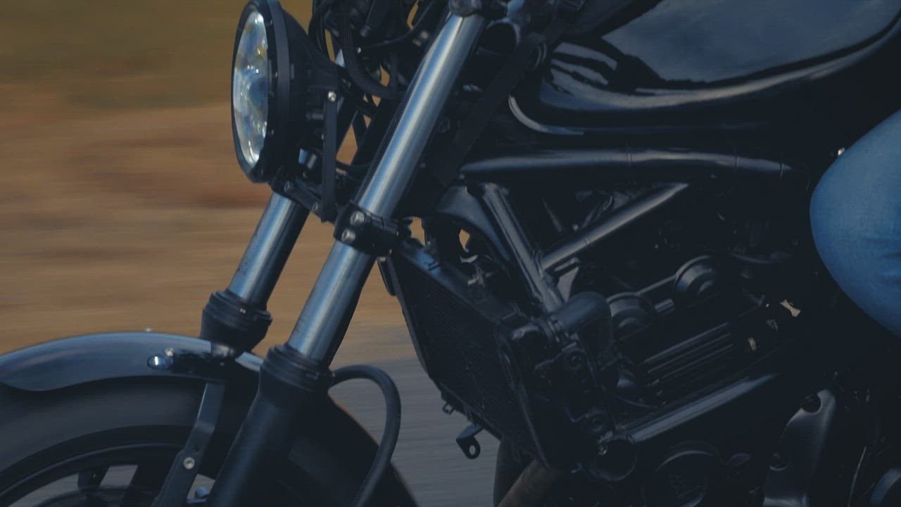 Motorcycle and its driver speeding down a road - Free Stock Video