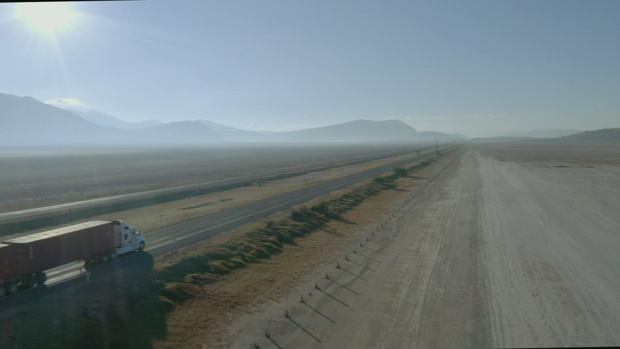 Flying over a long highway with cars and trucks - Free Stock Video