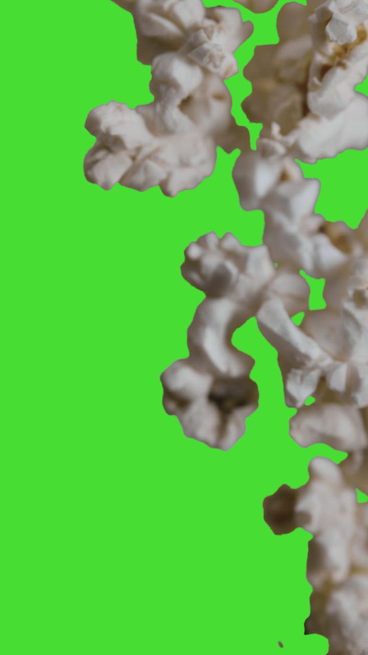 Popcorn moving on a green background - Free Stock Video