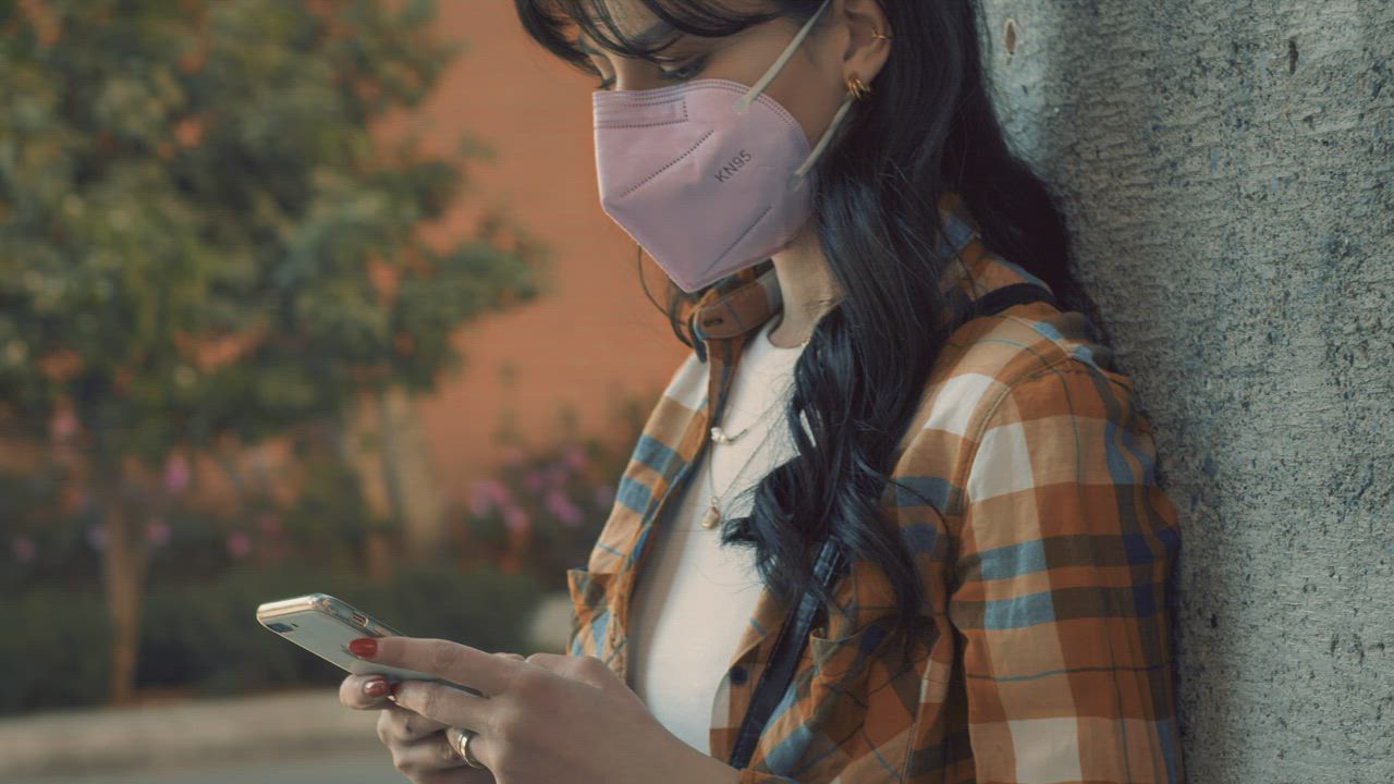 Woman with face mask while texting - Free Stock Video