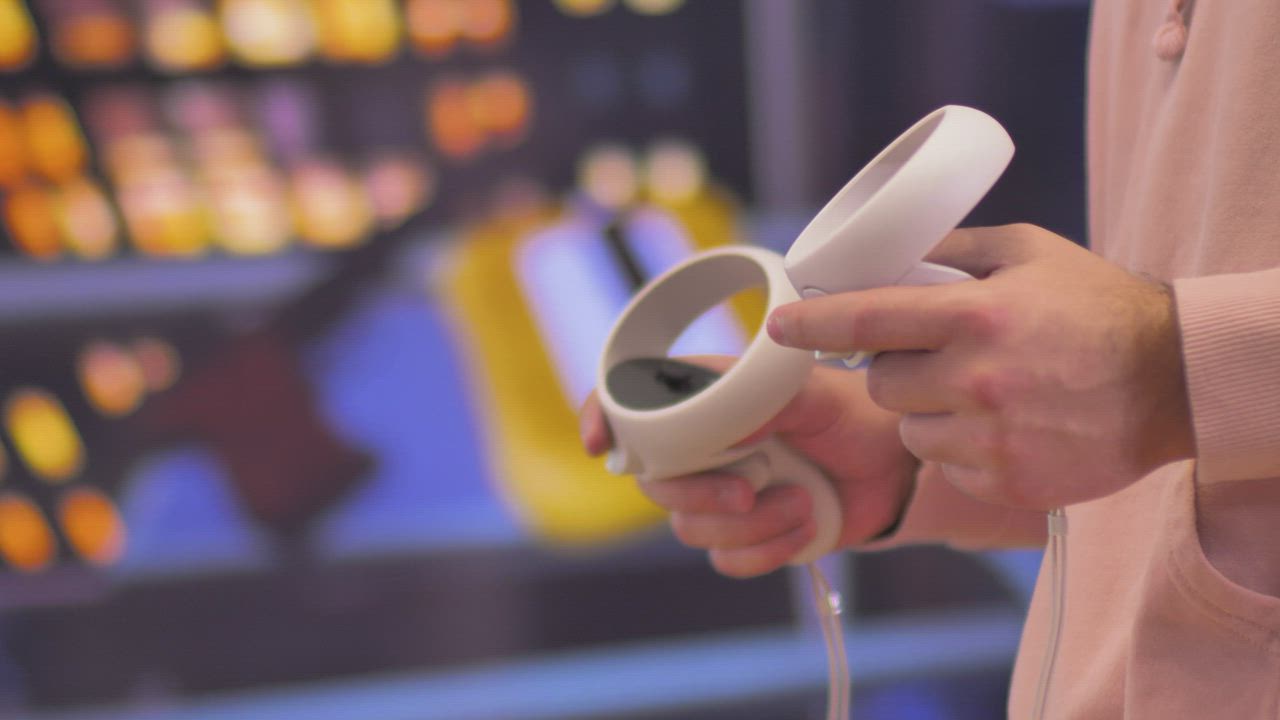 Hands of a gamer with VR controllers - Free Stock Video