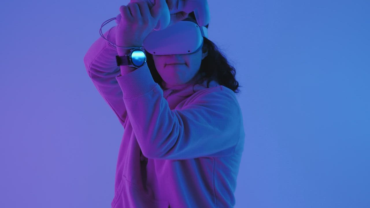 Gamer playing a fighting game with VR glasses - Free Stock Video