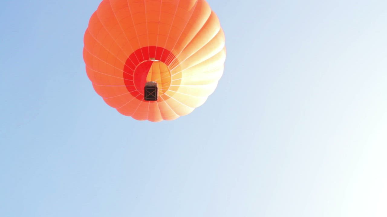 Orange hot air balloon flying - Free Stock Video