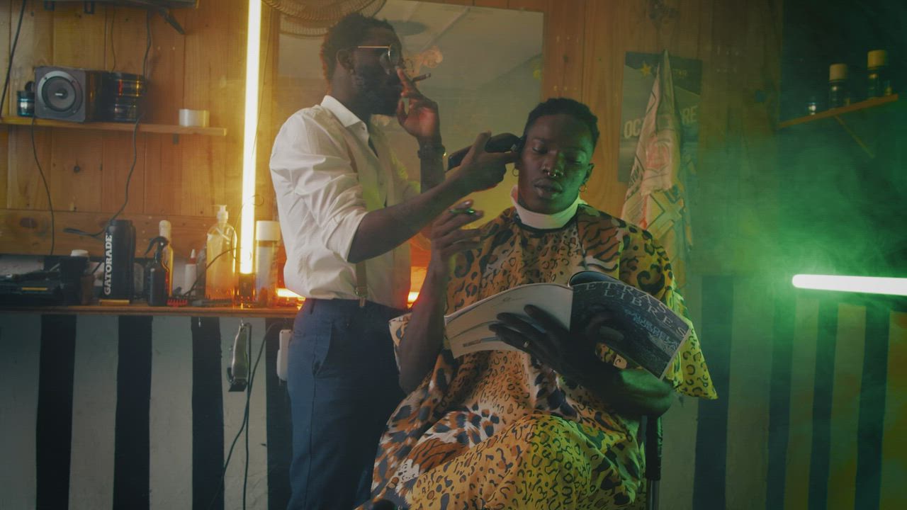 Barber and his client smoking cigar during haircut - Free Stock Video