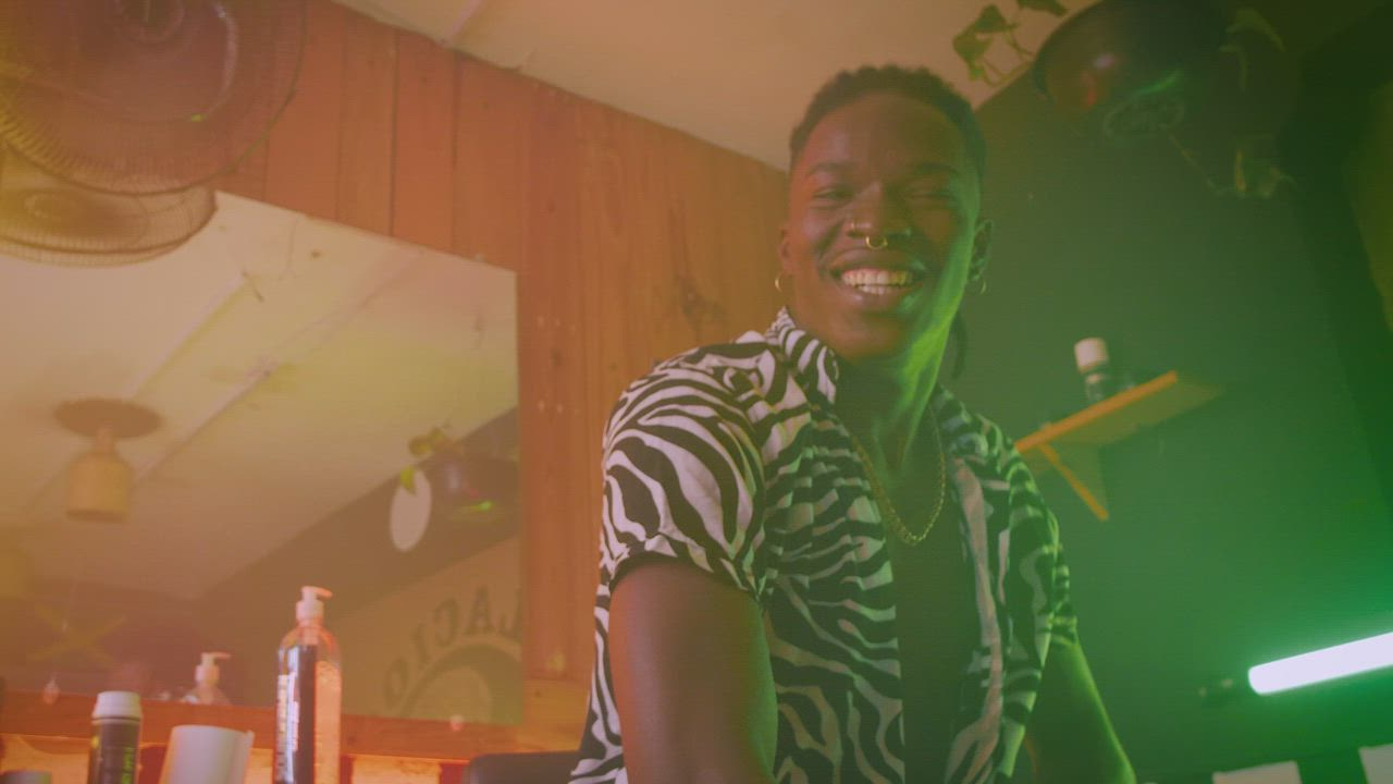 Young man singing and dancing in a barbershop - Free Stock Video