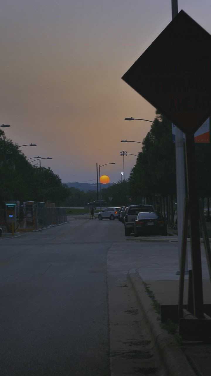 Sunset in the distance walking through the city - Free Stock Video