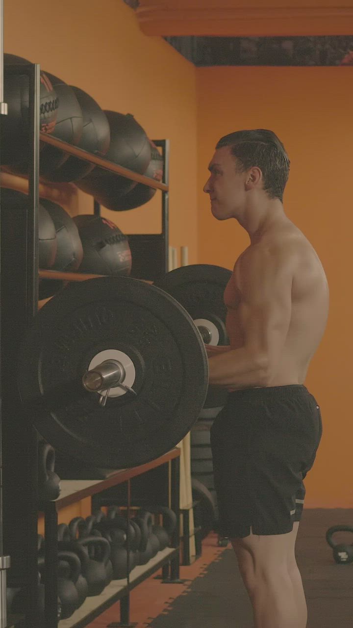 Athletic man doing reps with a large dumbbell - Free Stock Video