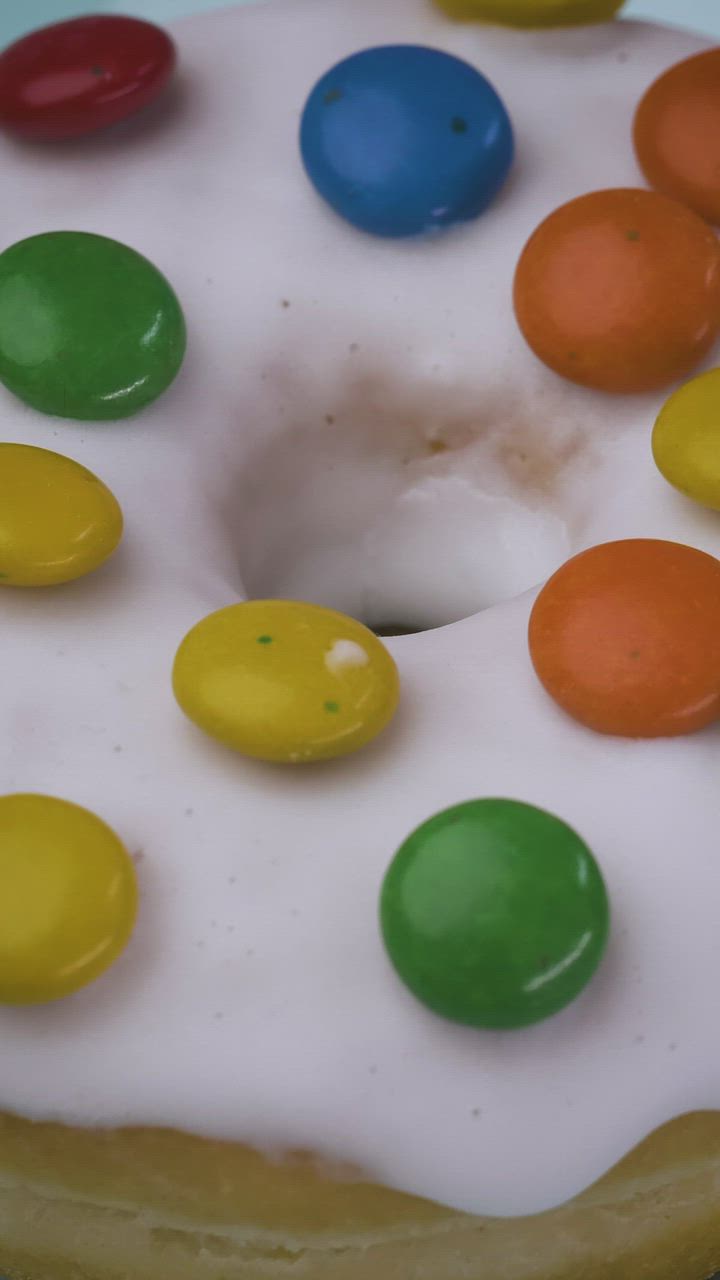 Texture of a glazed donut with colorful chocolates rotating - Free ...