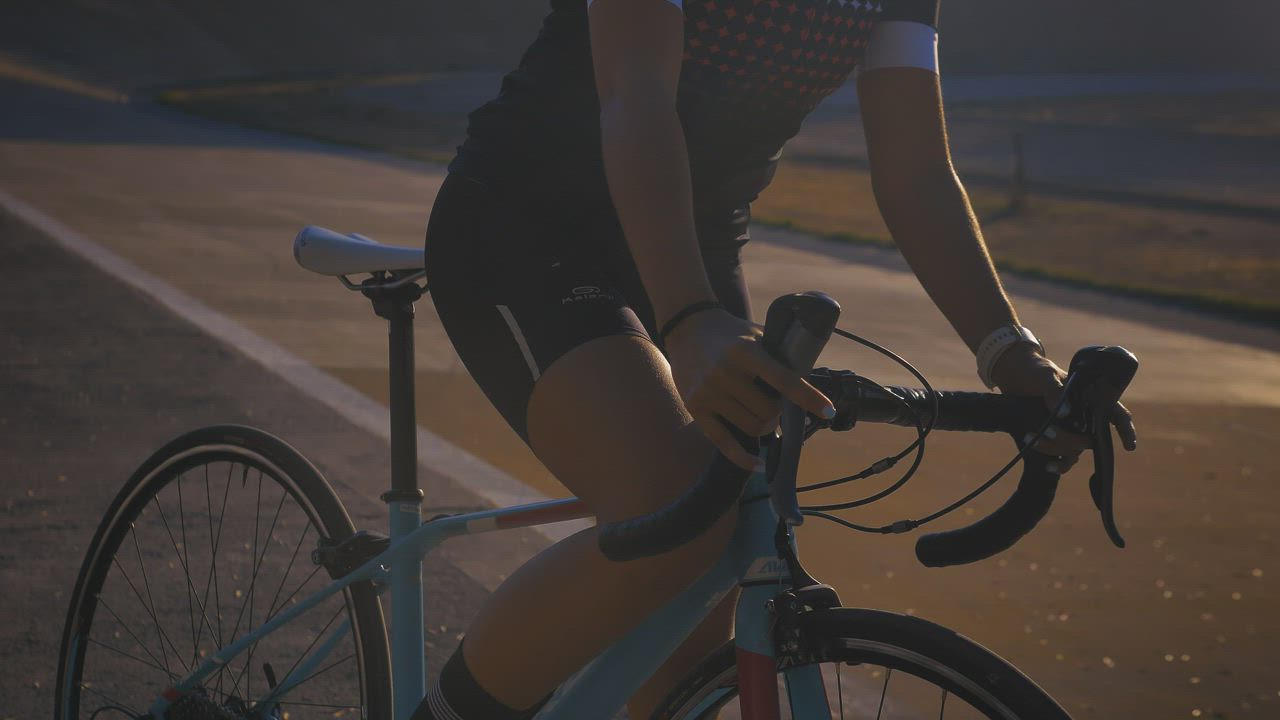 A woman on a bicycle starts on a cycling track - Free Stock Video