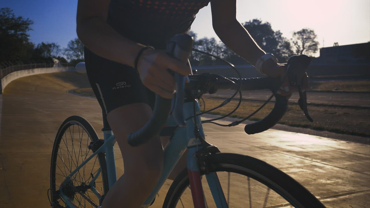 Cyclist riding on a cycling track outdoors - Free Stock Video