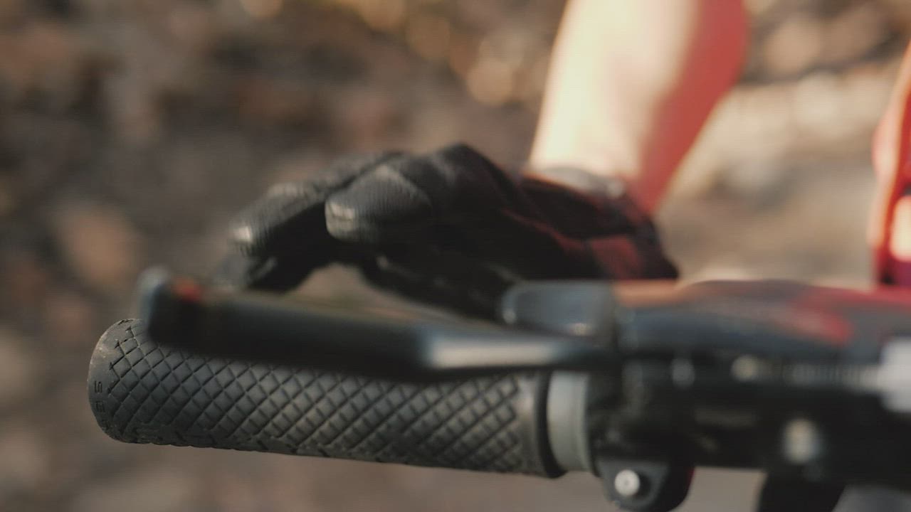 Motorcyclist placing his hands on the handlebars - Free Stock Video