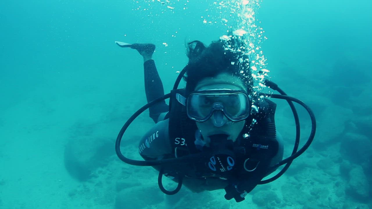 Person diving in a blue sea - Free Stock Video