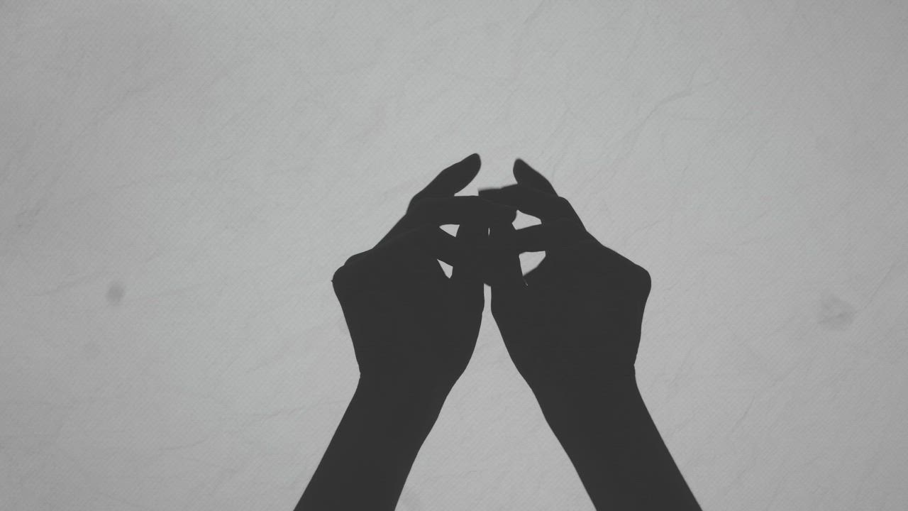 Silhouette of a woman's hands moving them gently - Free Stock Video
