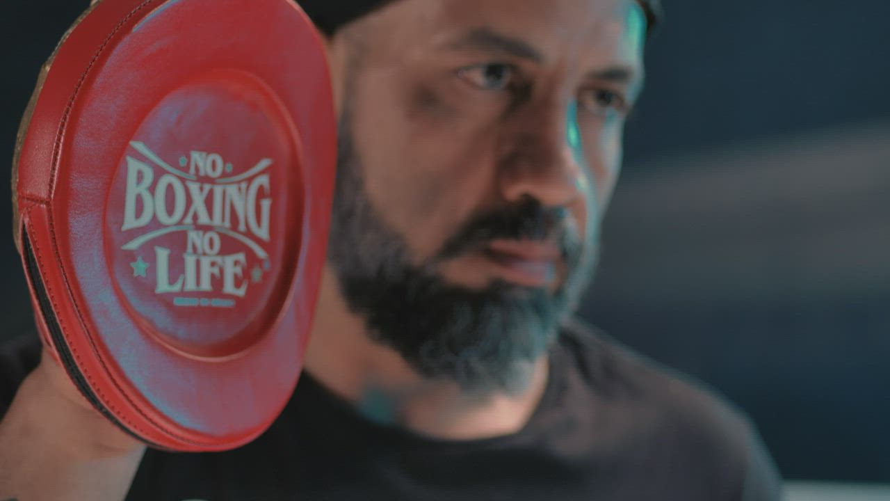 Boxing coach getting punches on a pad - Free Stock Video