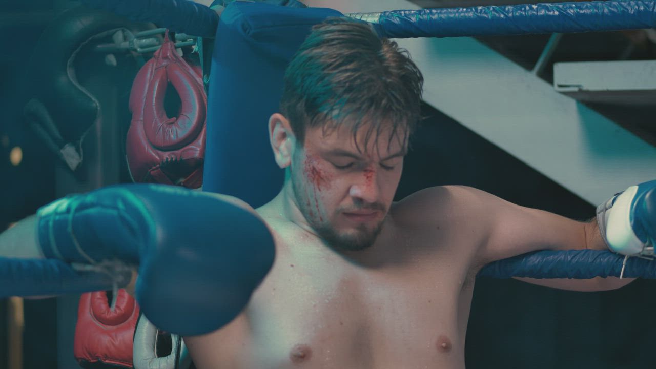 Injured boxer sitting in the ring - Free Stock Video