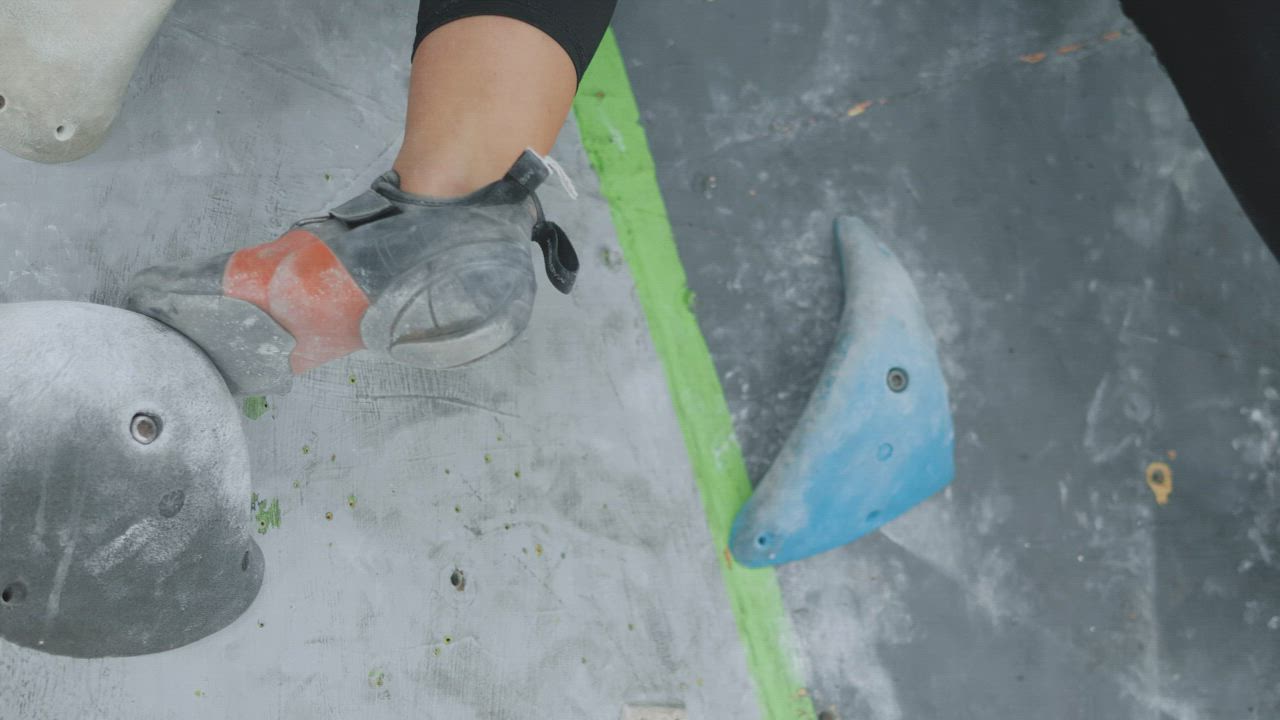 Low girl climbing up a mountaineering wall - Free Stock Video
