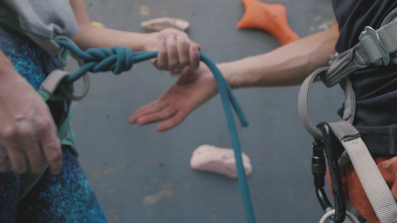 Two people adjusting harnesses on their body - Free Stock Video
