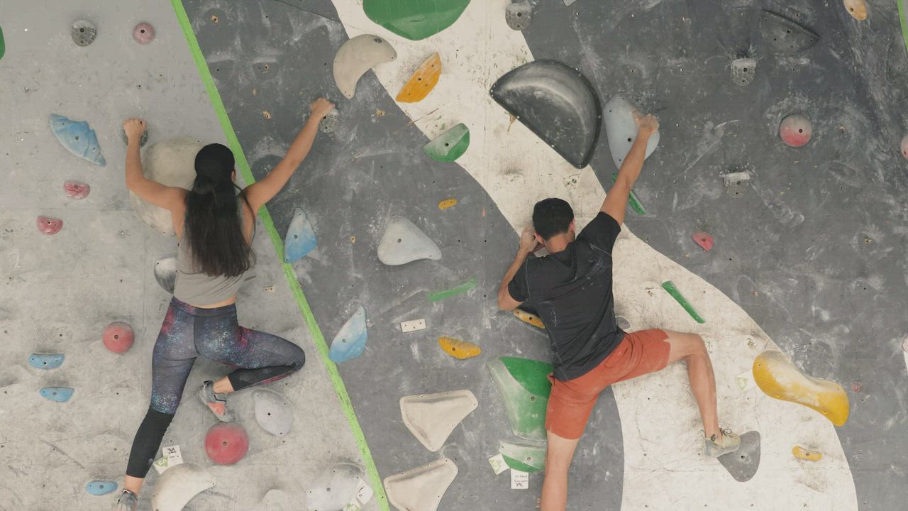 Two people practicing mountaineering on a wall - Free Stock Video