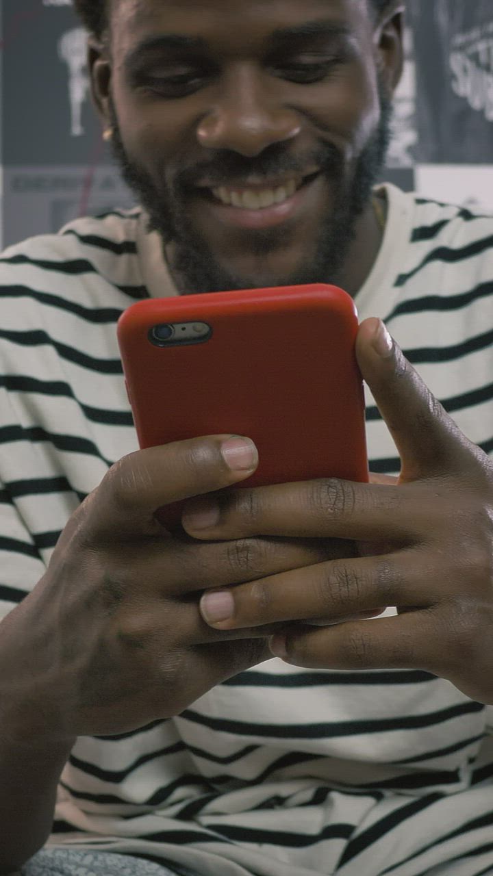 Happy man texting on his smartphone - Free Stock Video