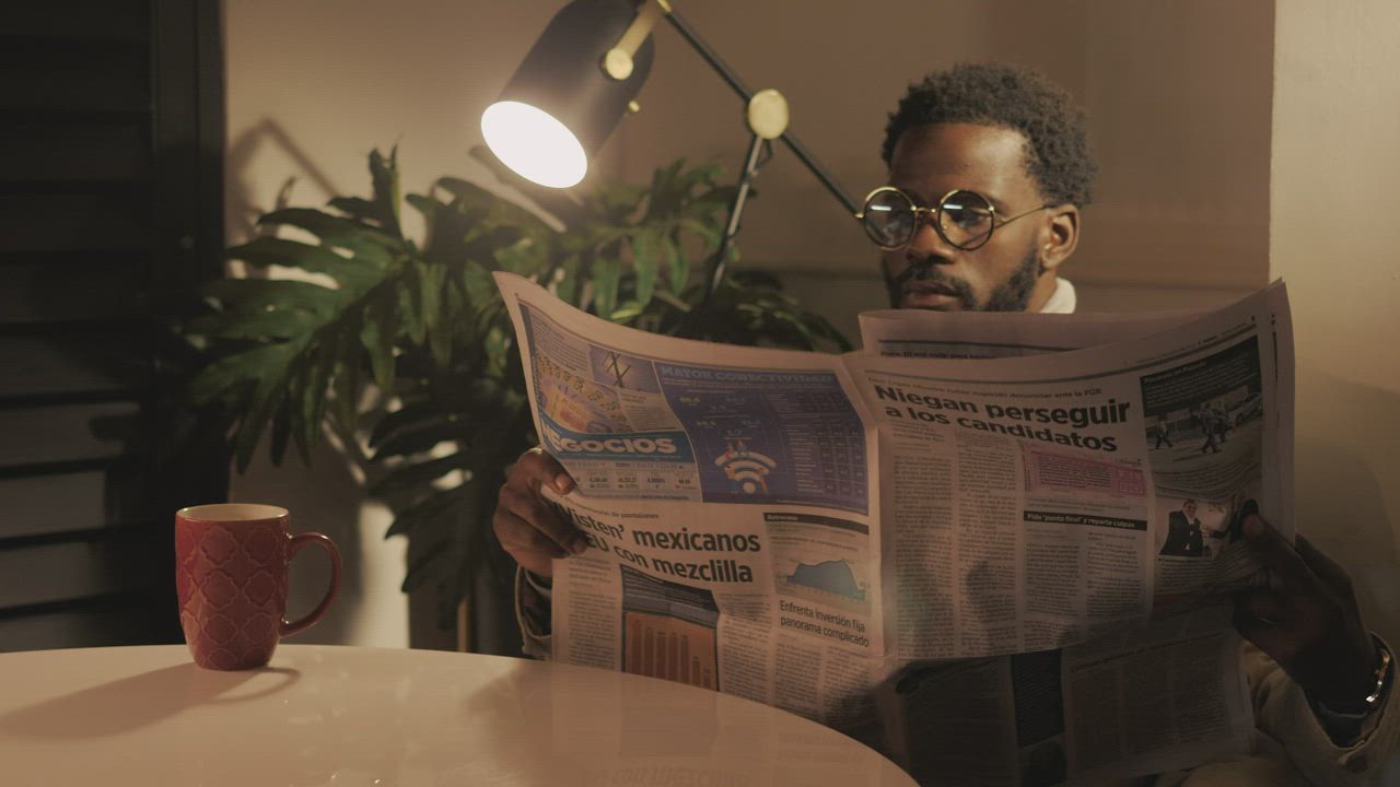 Intellectual man reading the newspaper with a cup of coffee - Free ...