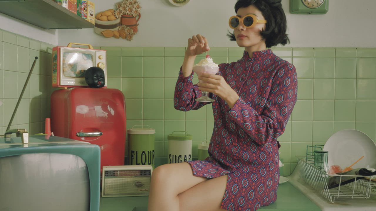 Retro woman eating an ice cream in the kitchen - Free Stock Video