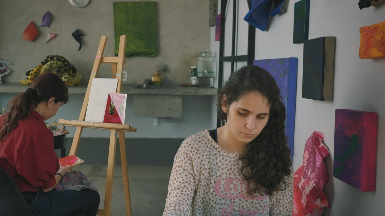 Two artist girls working in an artistic workshop - Free Stock Video