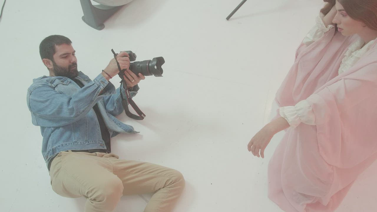 Experienced photographer portraying a girl on set - Free Stock Video