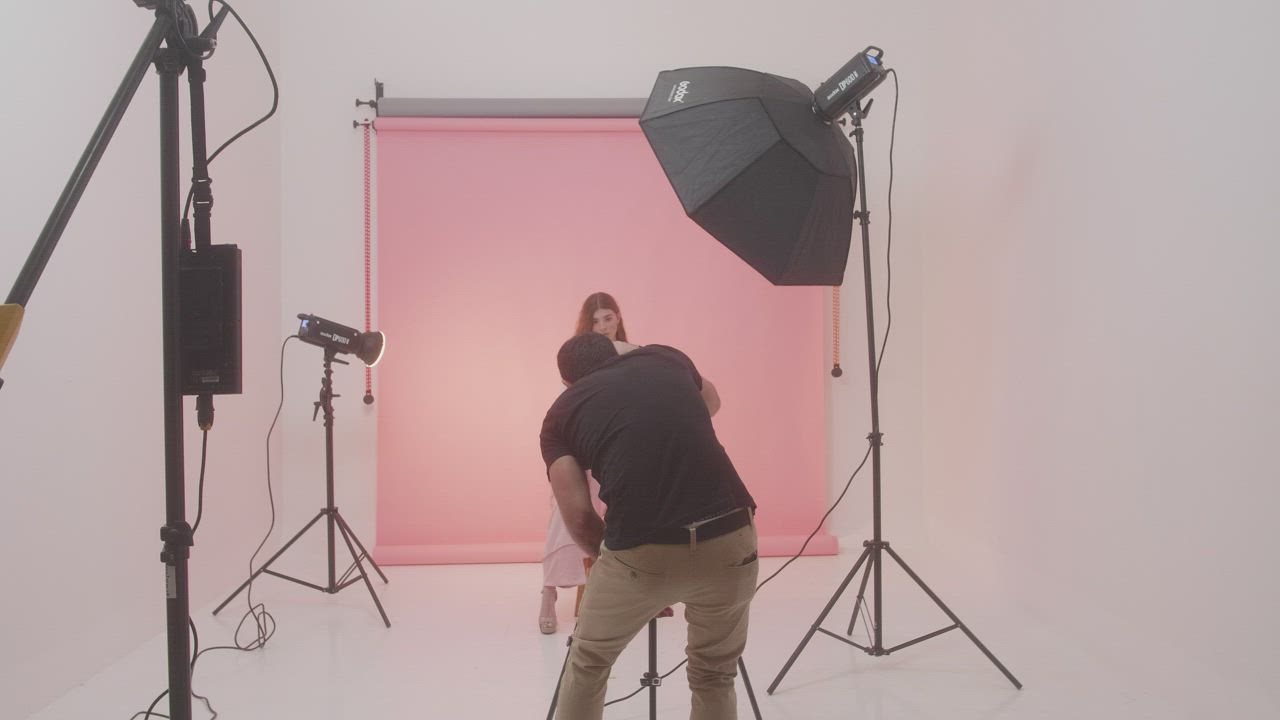 Photo session with a model in a professional studio - Free Stock Video
