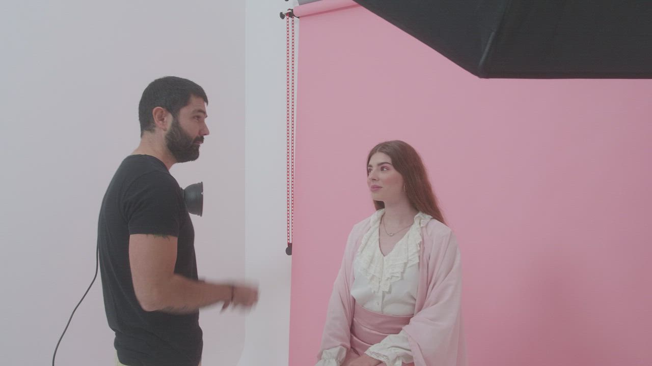 Photographer giving directions to a model in a session - Free Stock Video