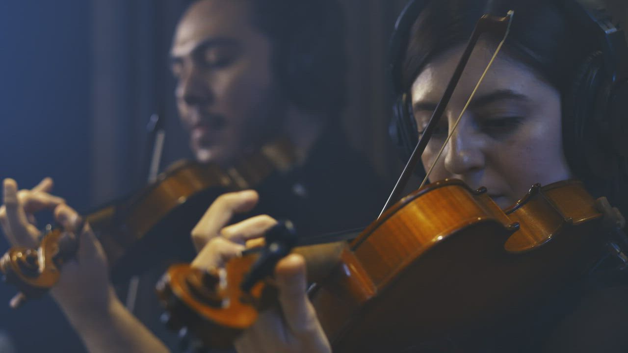 Two violinists playing together recording in a studio - Free Stock Video