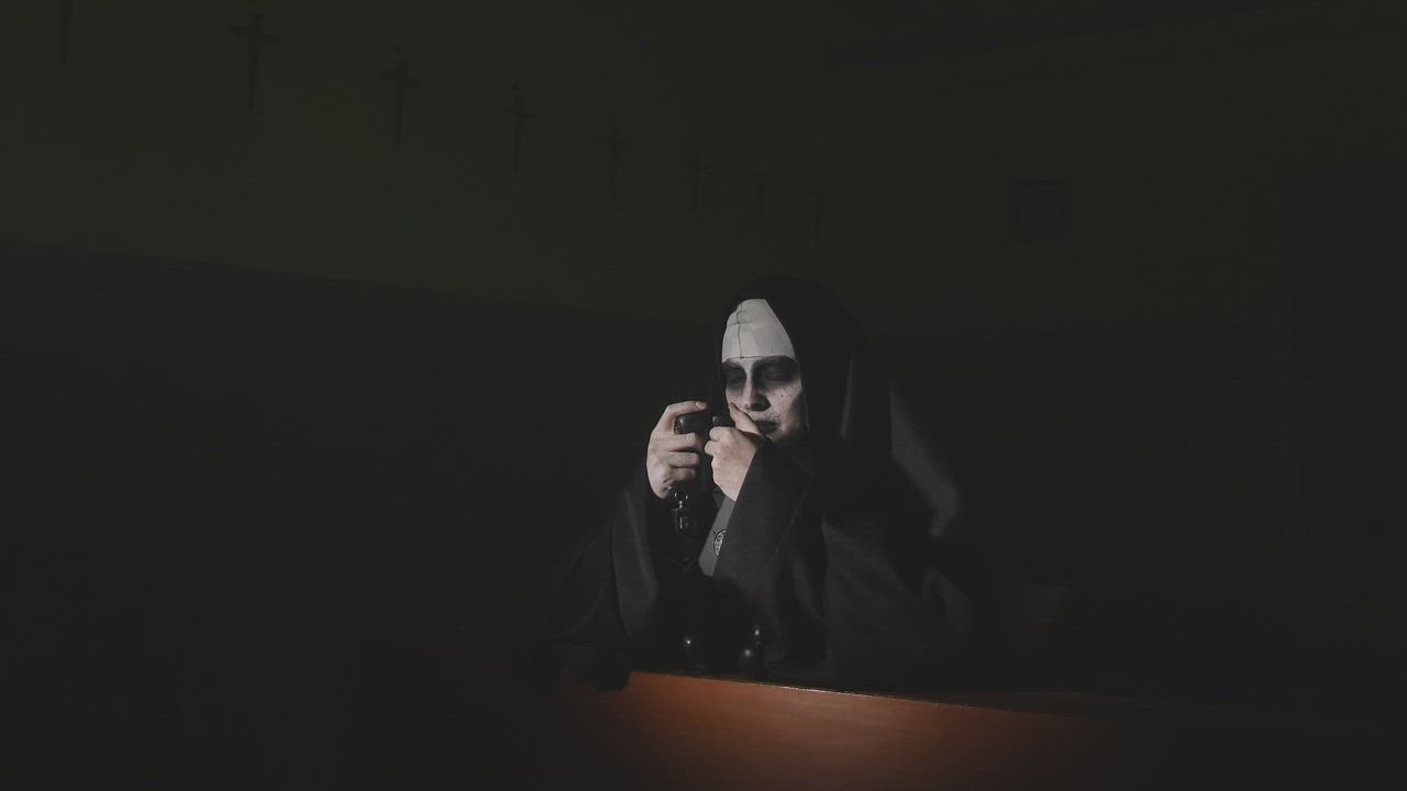 Ghost nun praying in a dark temple - Free Stock Video